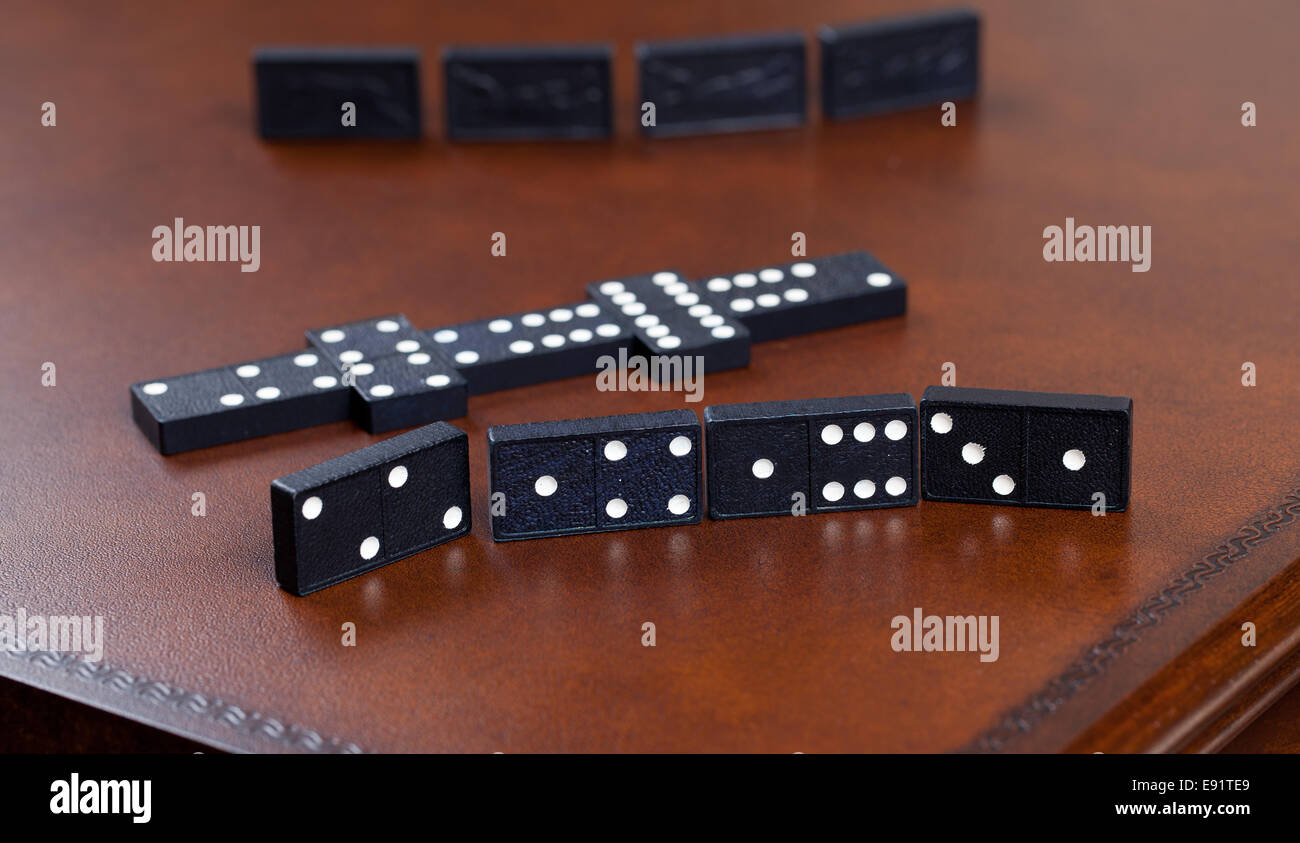 Game of dominoes on leather table Stock Photo - Alamy