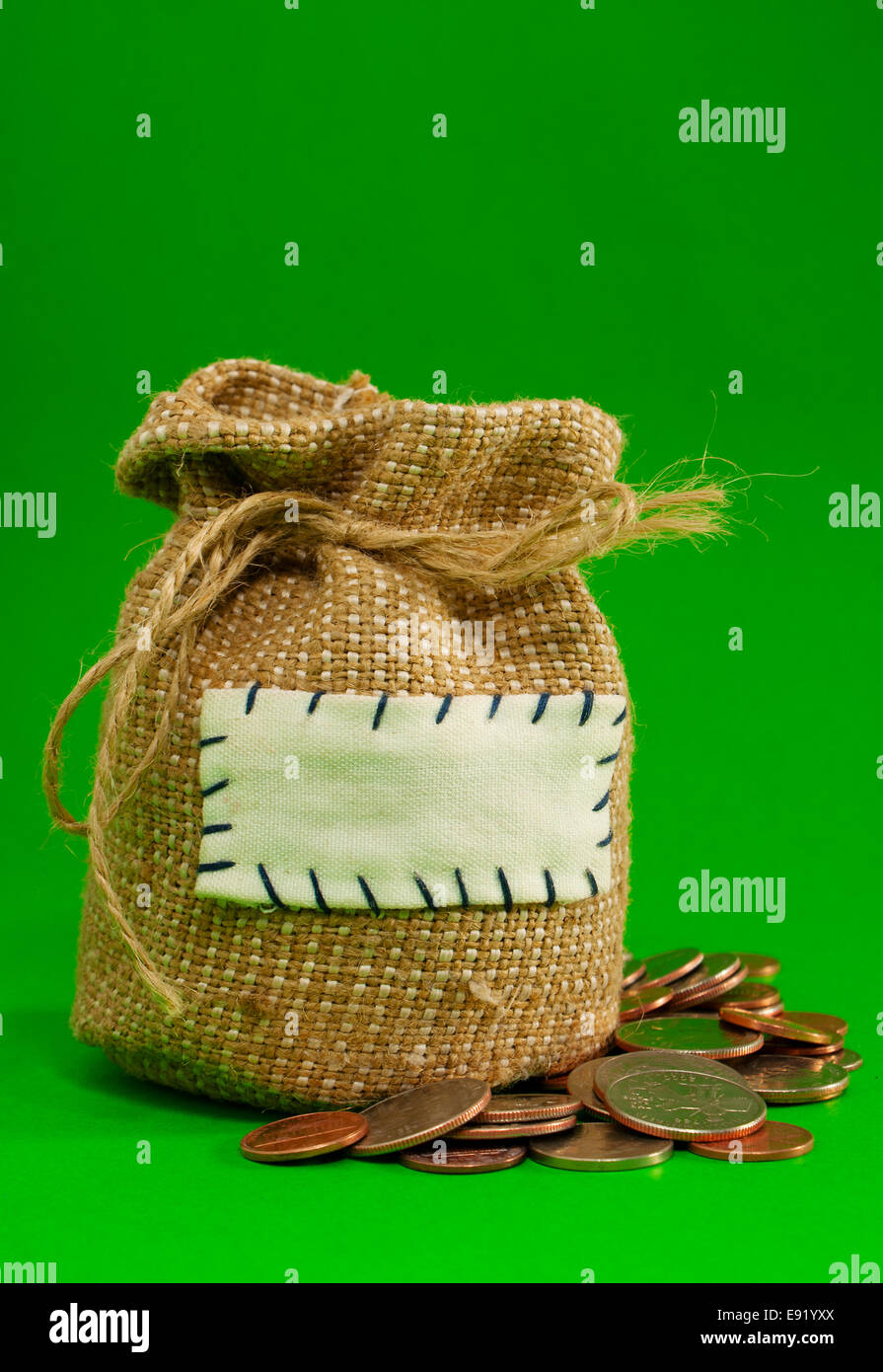 Sack full of coins over green background Stock Photo - Alamy