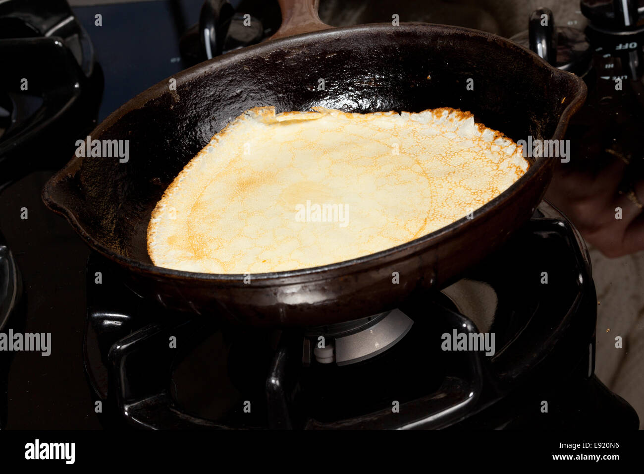Frying pancake mix into pan Stock Photo - Alamy