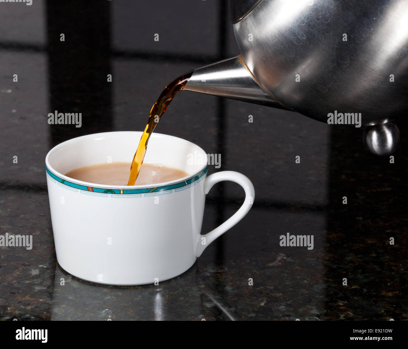 Tea poured from stainless steel teapot Stock Photo - Alamy