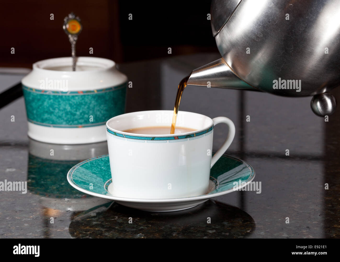 Tea poured from stainless steel teapot Stock Photo - Alamy