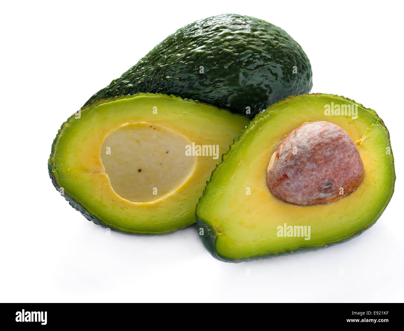 Avocado cut in half against white background Stock Photo - Alamy