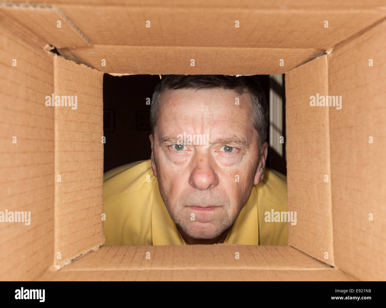 Senior man staring into cardboard box Stock Photo - Alamy