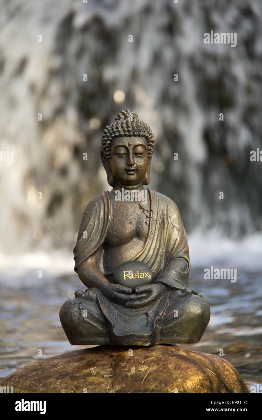 Buddha relax meditation by the waterfall Stock Photo - Alamy
