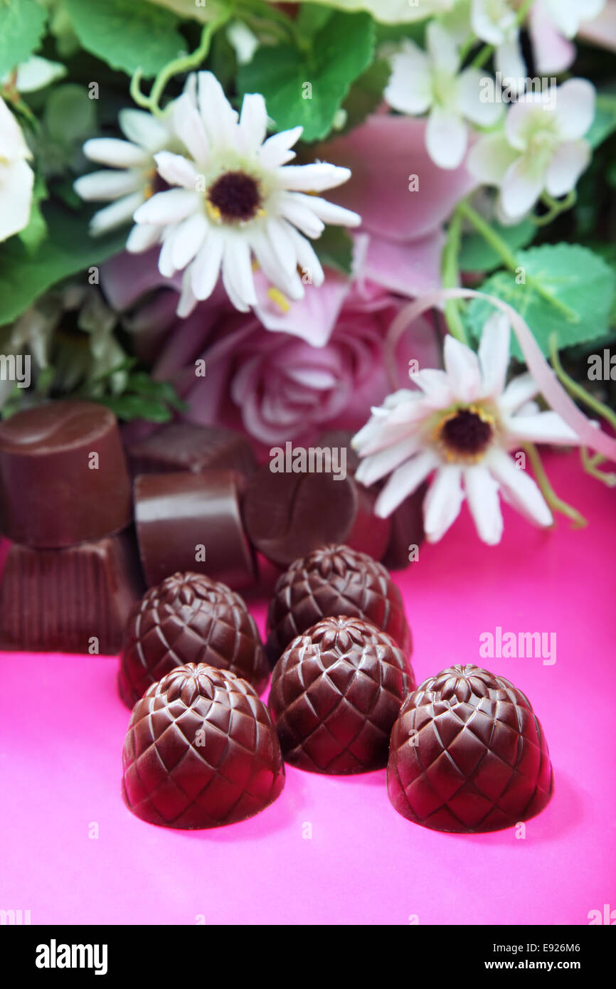 Chocolate sweets and flowers Stock Photo - Alamy
