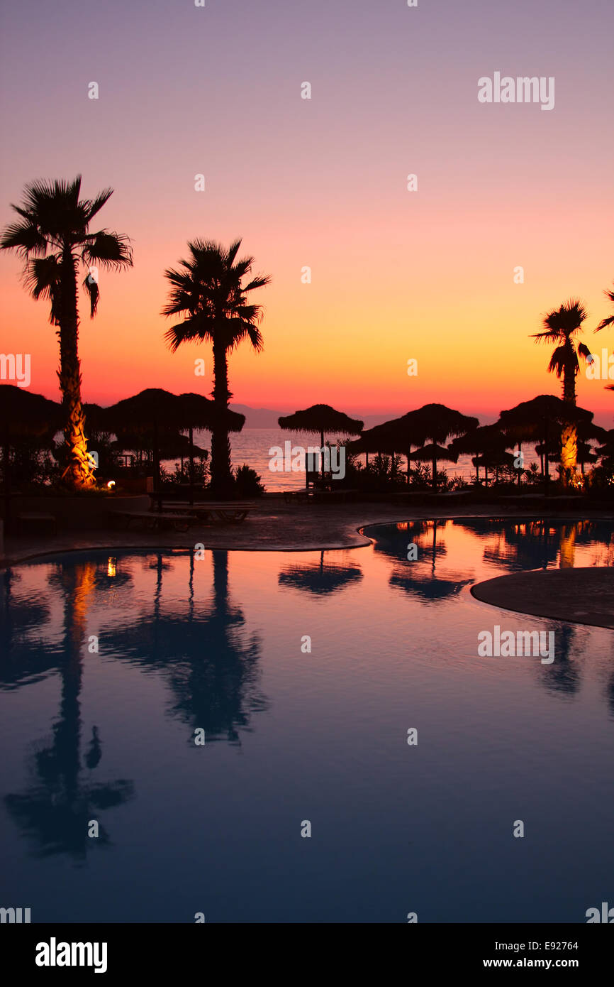 Resort pool at sunset Stock Photo - Alamy