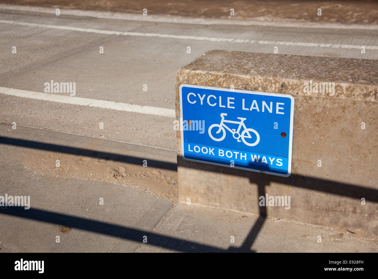 Blue cycle path lane sign by beach Stock Photo - Alamy