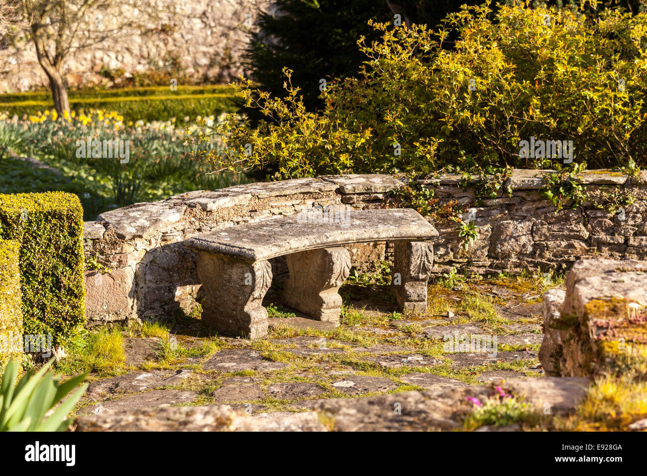 Old stone carved bench in garden Stock Photo - Alamy