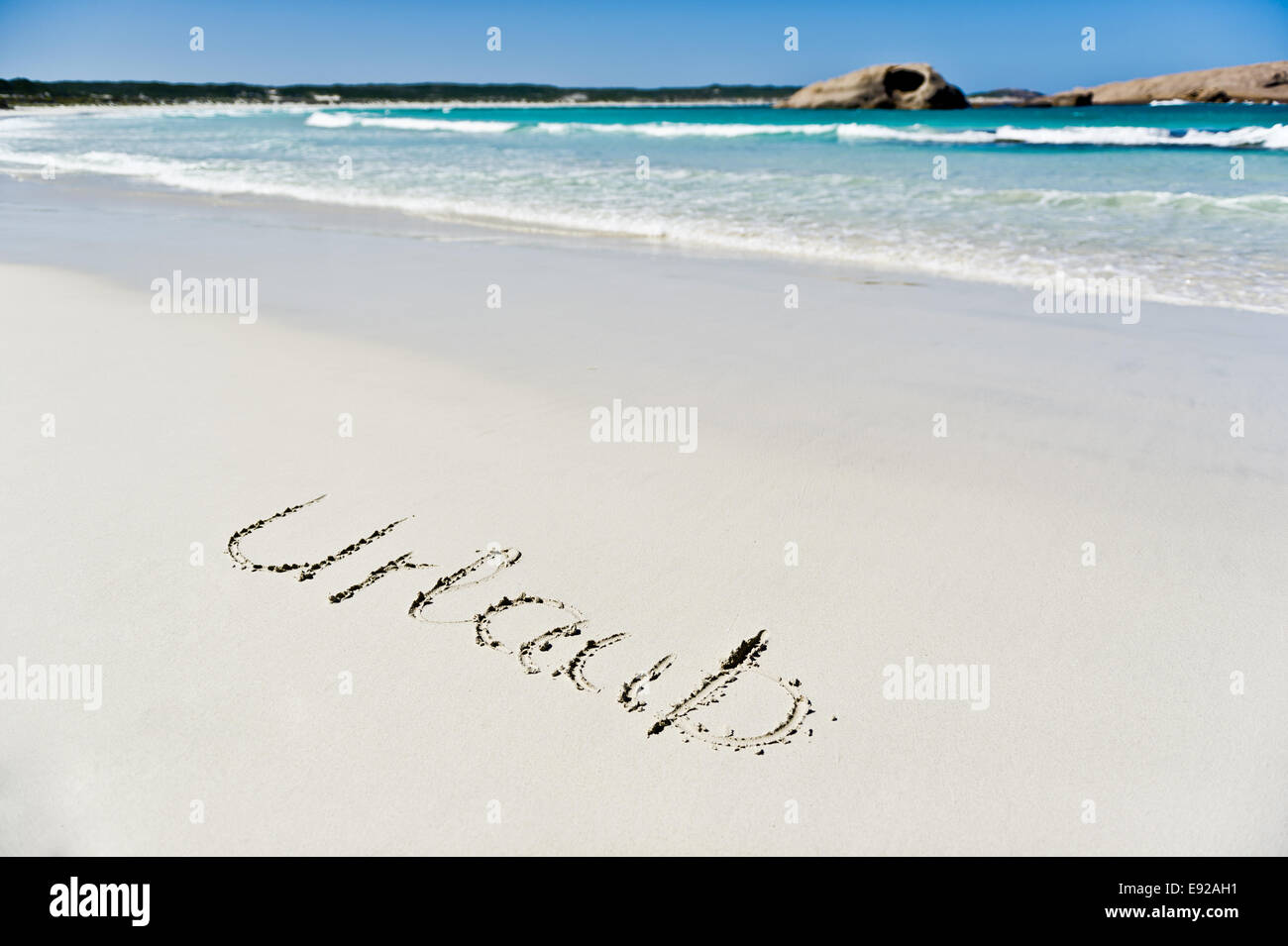 Holiday written in the sand Stock Photo - Alamy