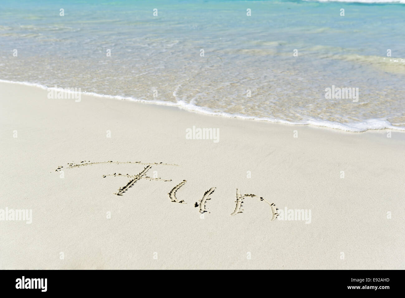 Fun written in the sand Stock Photo - Alamy