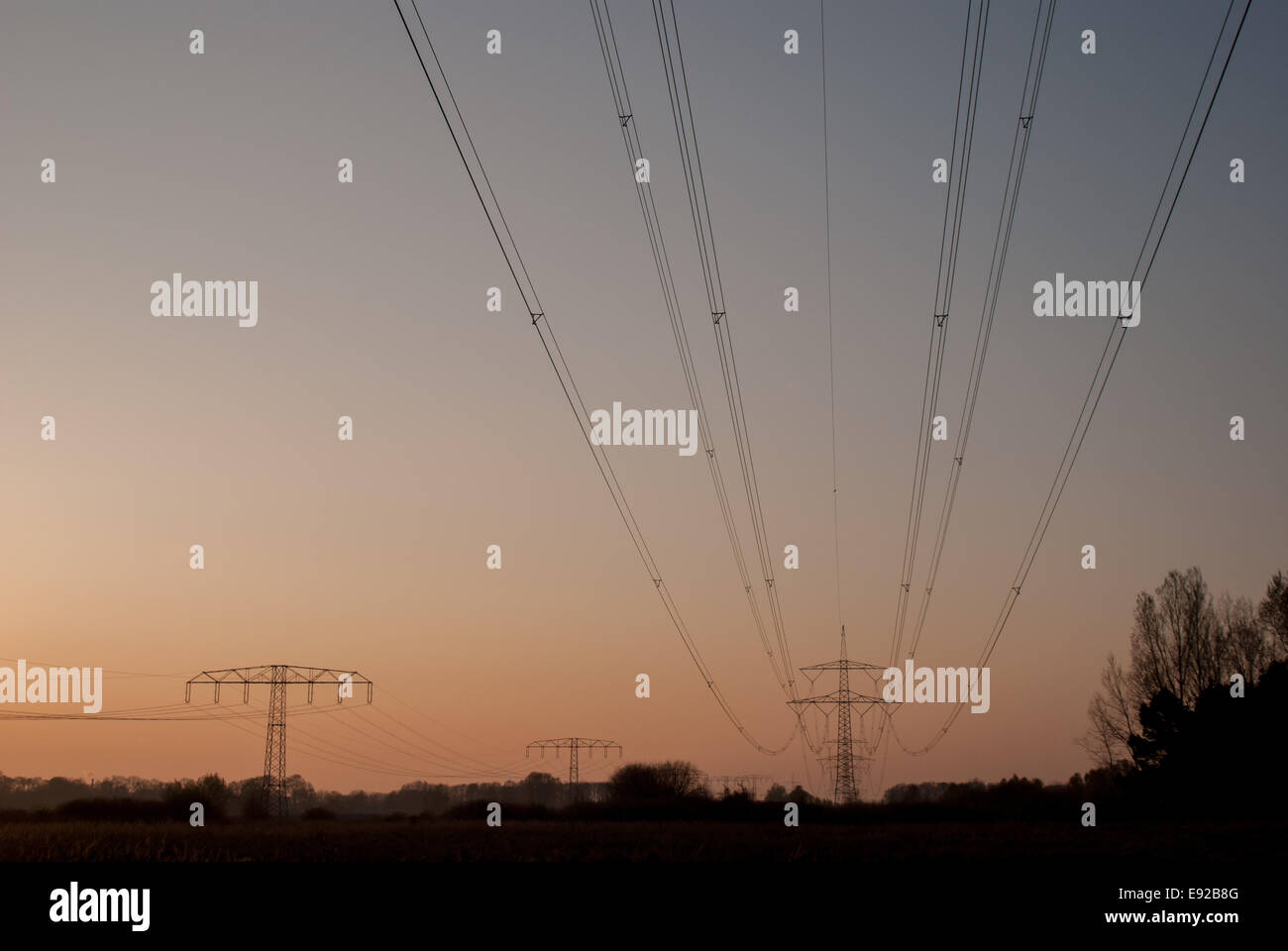 Power lines at sunset Stock Photo - Alamy