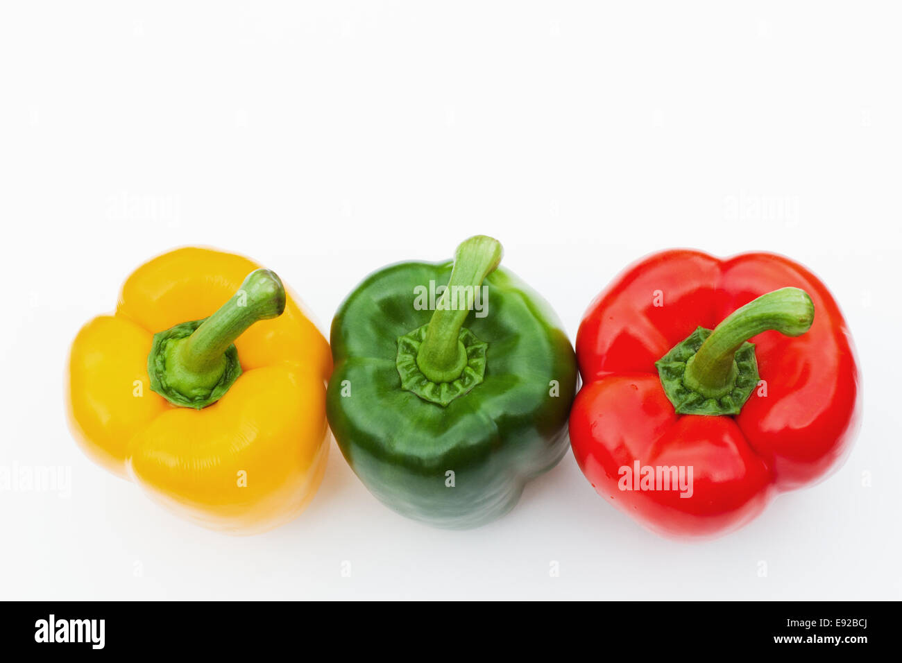 three bell peppers in a row Stock Photo - Alamy