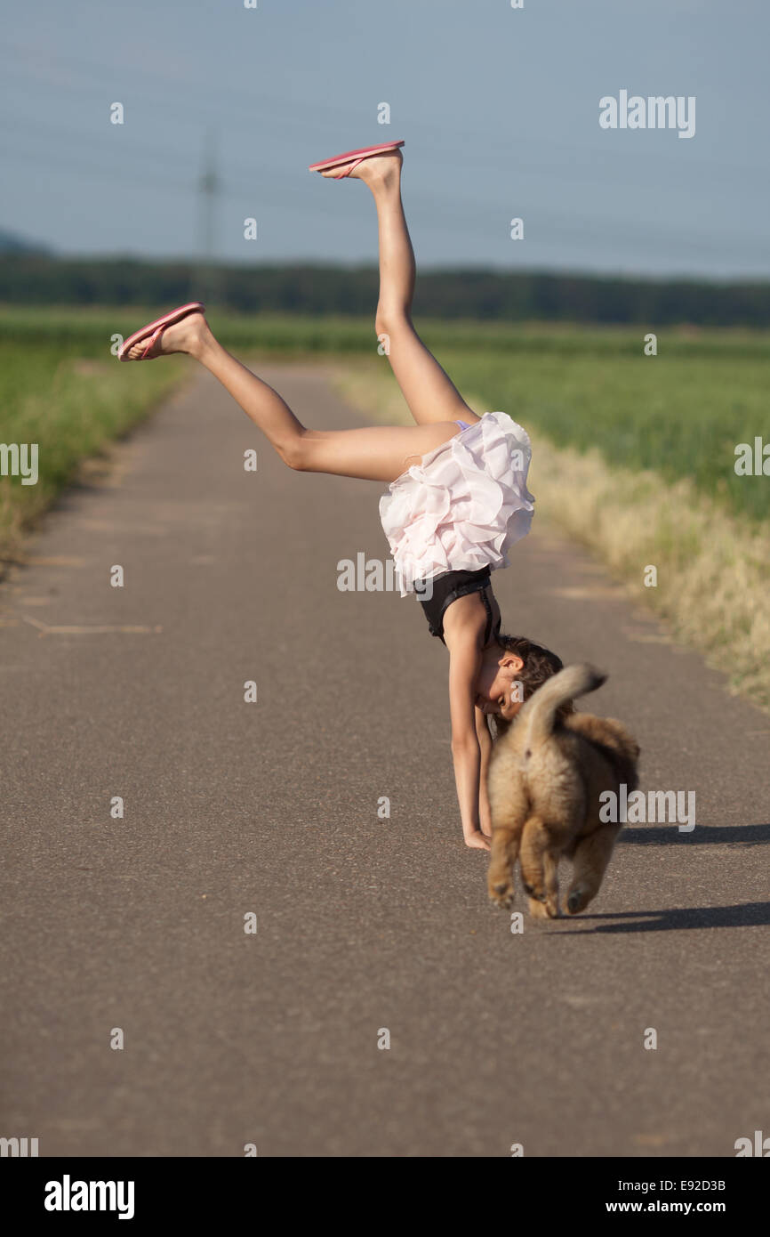 girl makes handstand on the road Stock Photo - Alamy