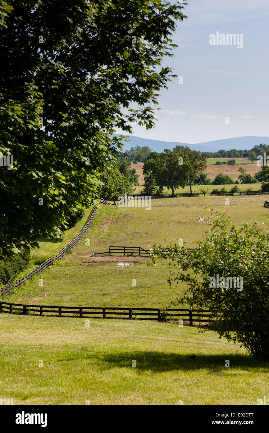 Rolling meadows with wooden fences and hills Stock Photo - Alamy