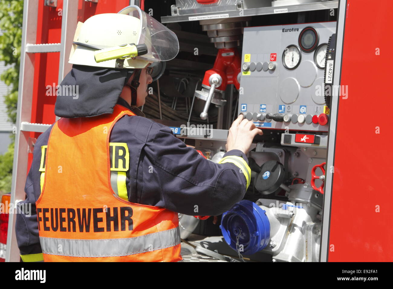 Firefighter operating an engine Stock Photo - Alamy