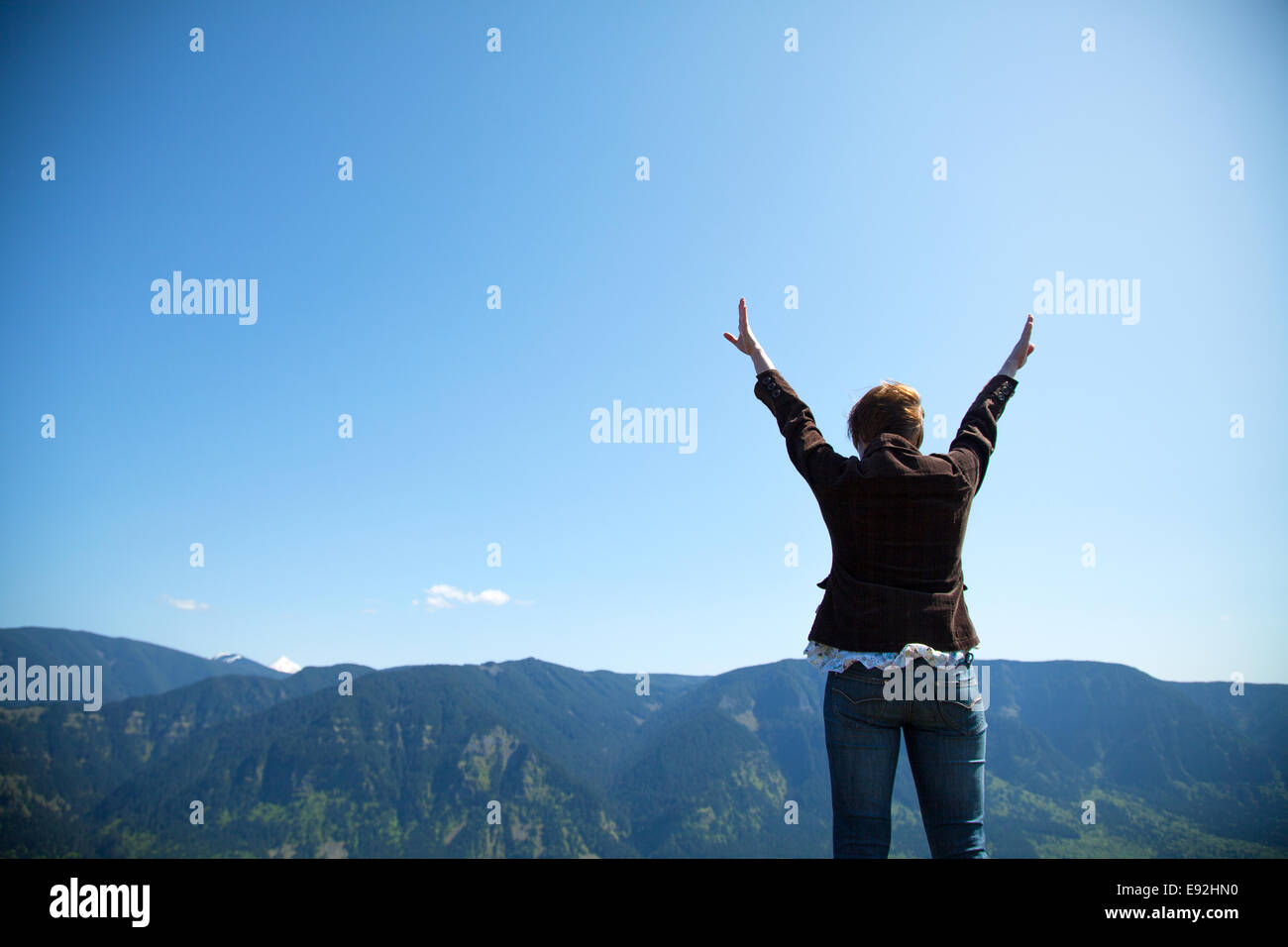 Woman with raised hands Stock Photo - Alamy