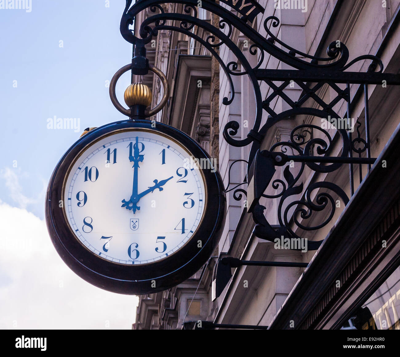 A clock outside a business Stock Photo - Alamy