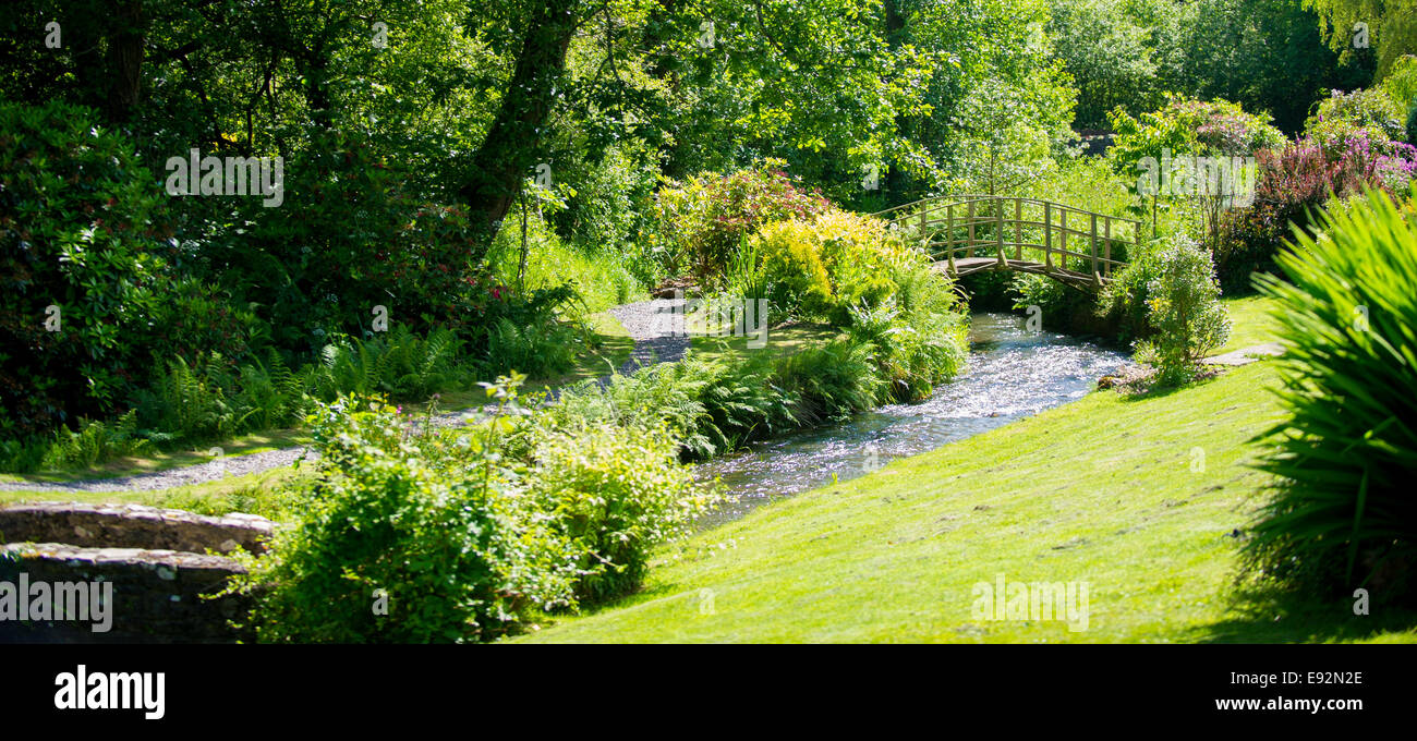 Bridge over stream Devon garden Stock Photo - Alamy