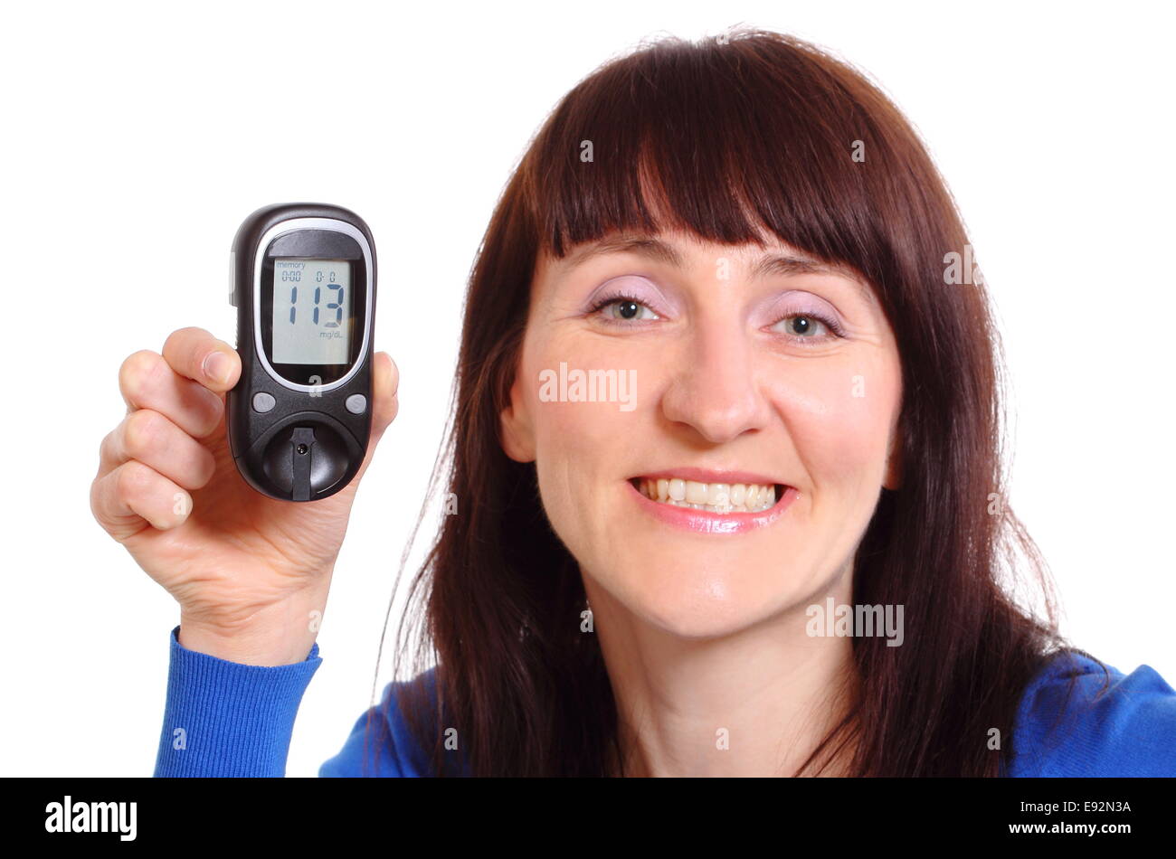 Smiling woman holding glucose meter, measuring sugar level, glucometer ...