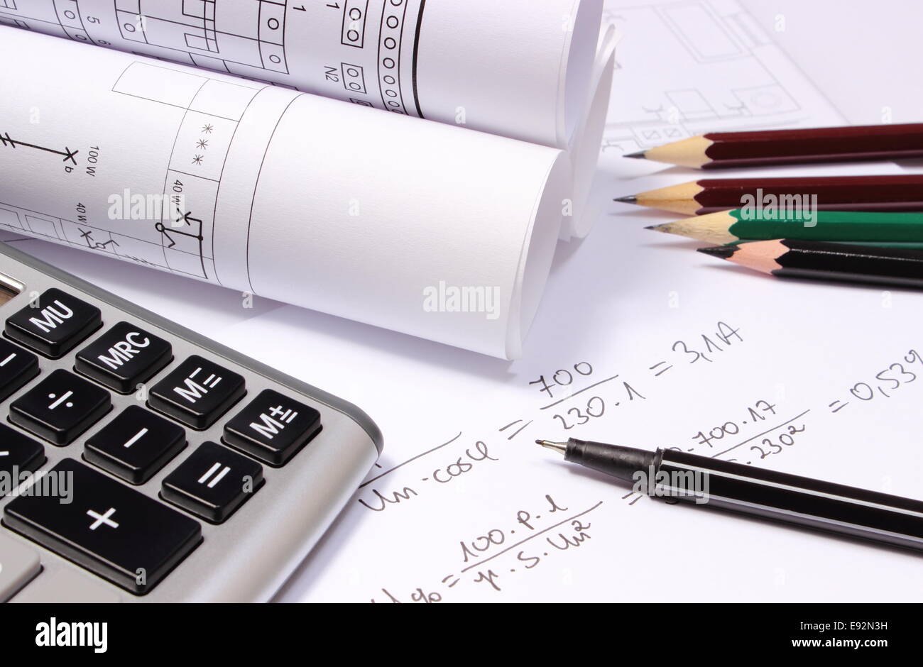 Rolled electrical diagrams, calculator, pencils and mathematical ...