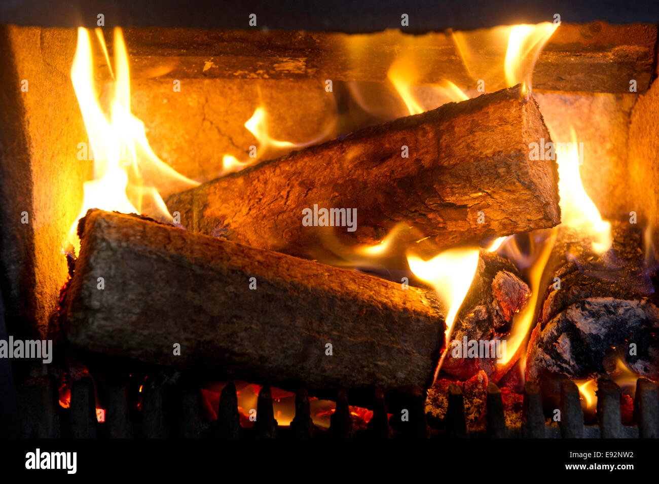 Eco logs in fireplace Stock Photo - Alamy