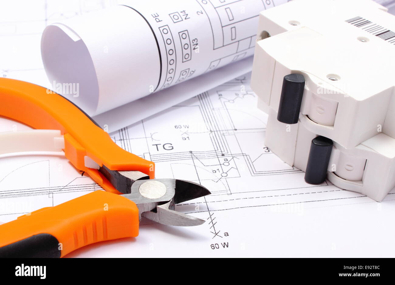Rolled electrical diagrams, electric fuse and work tools lying on ...