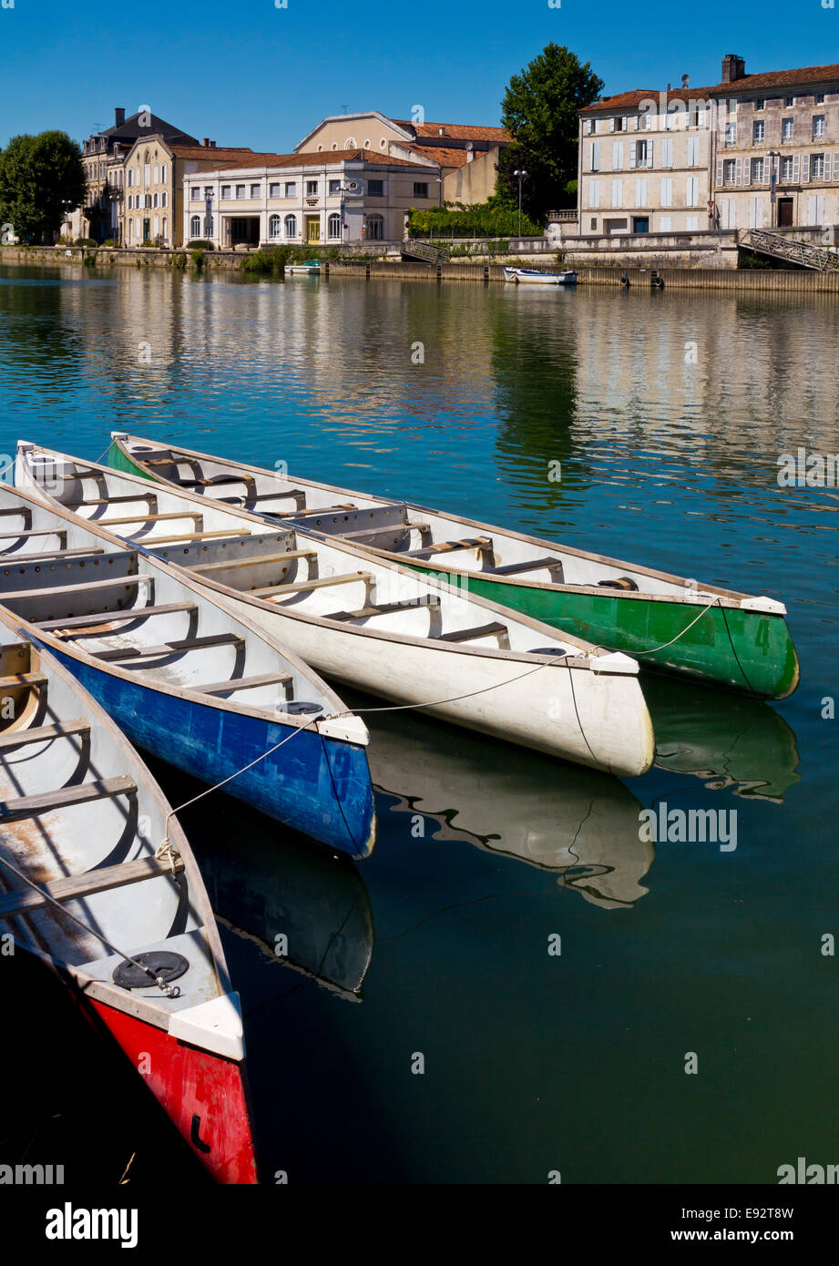 Rowing boats moored on the River Charente flowing through Jarnac in the ...