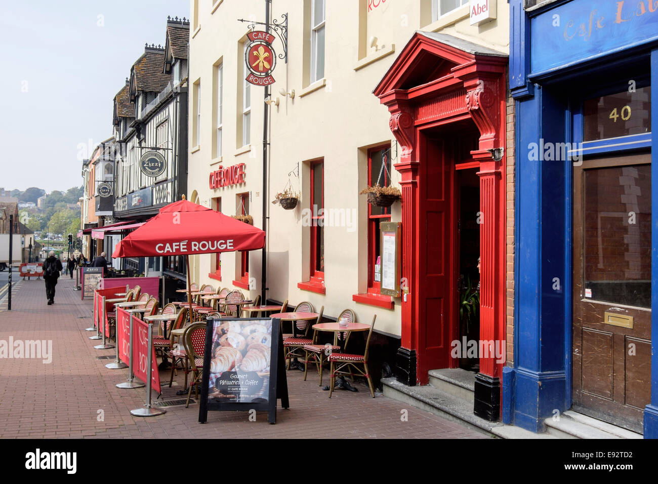Cafe Rouge with tables and chairs outside on a pavement in an urban ...