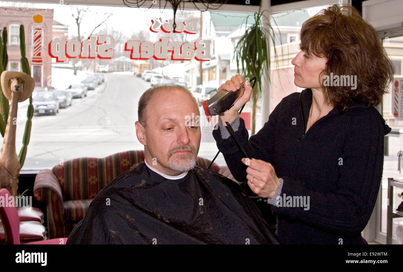 Female barber cuts man's hair in barber shop Stock Photo - Alamy