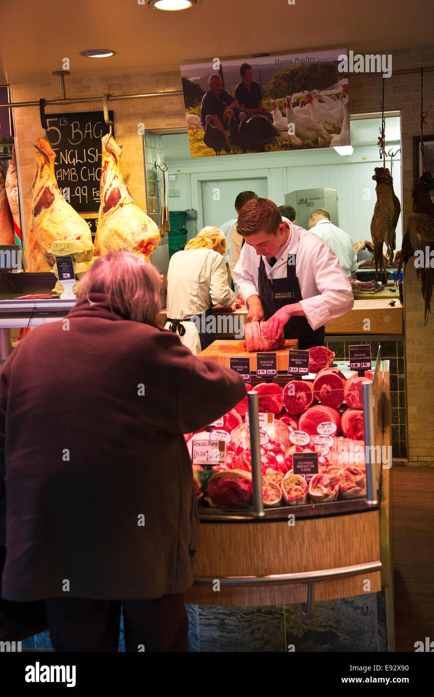 A butcher cutting meat at the counter Stock Photo - Alamy