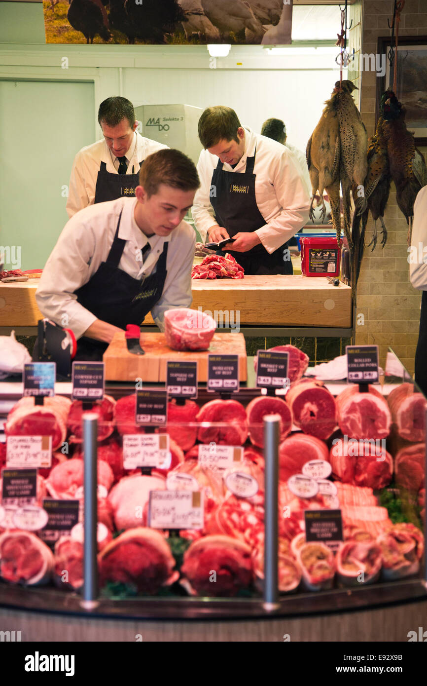 cutting up meat in a butchers shop Stock Photo - Alamy