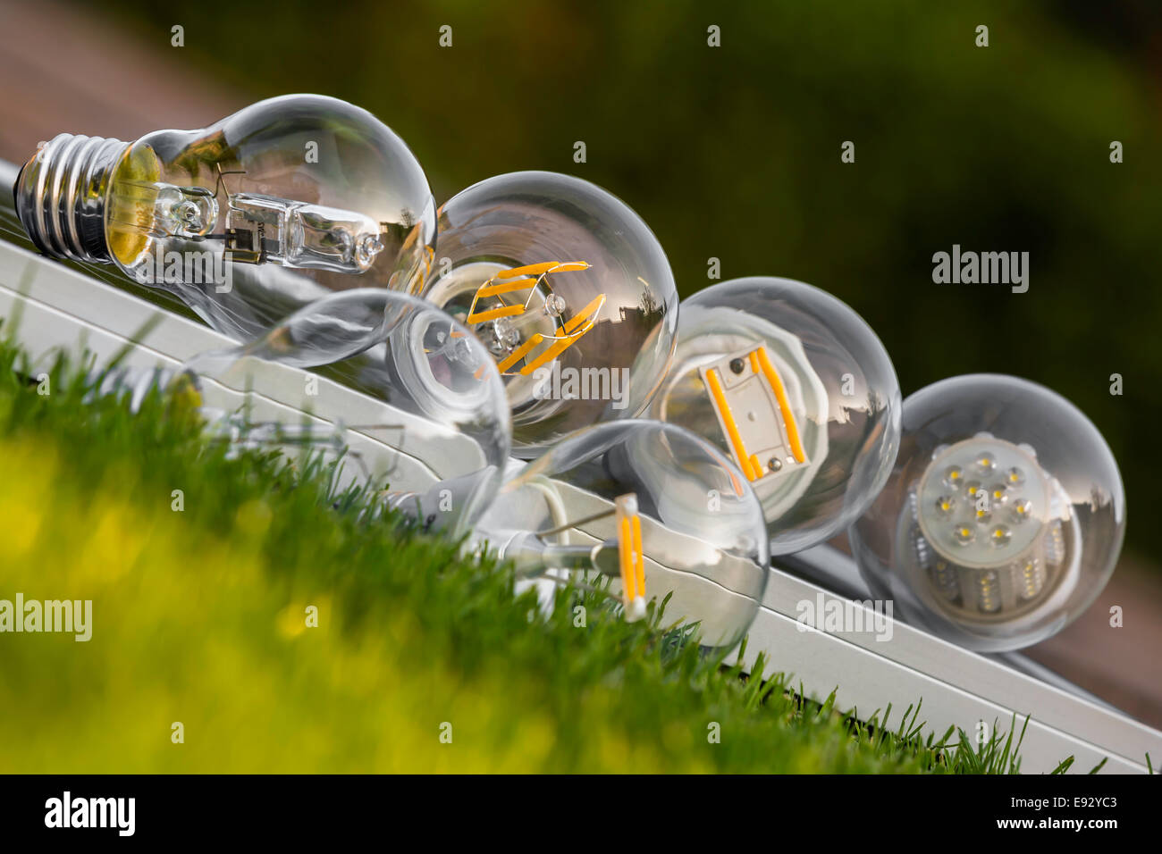 various E27 bulbs, LED, halogen and tungsten bulb on solar panel, some ...