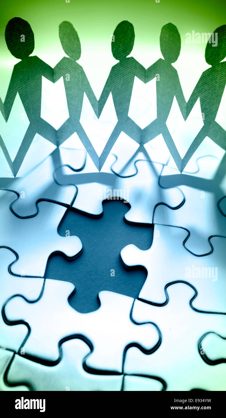 Team holding hands on jigsaw puzzle Stock Photo - Alamy