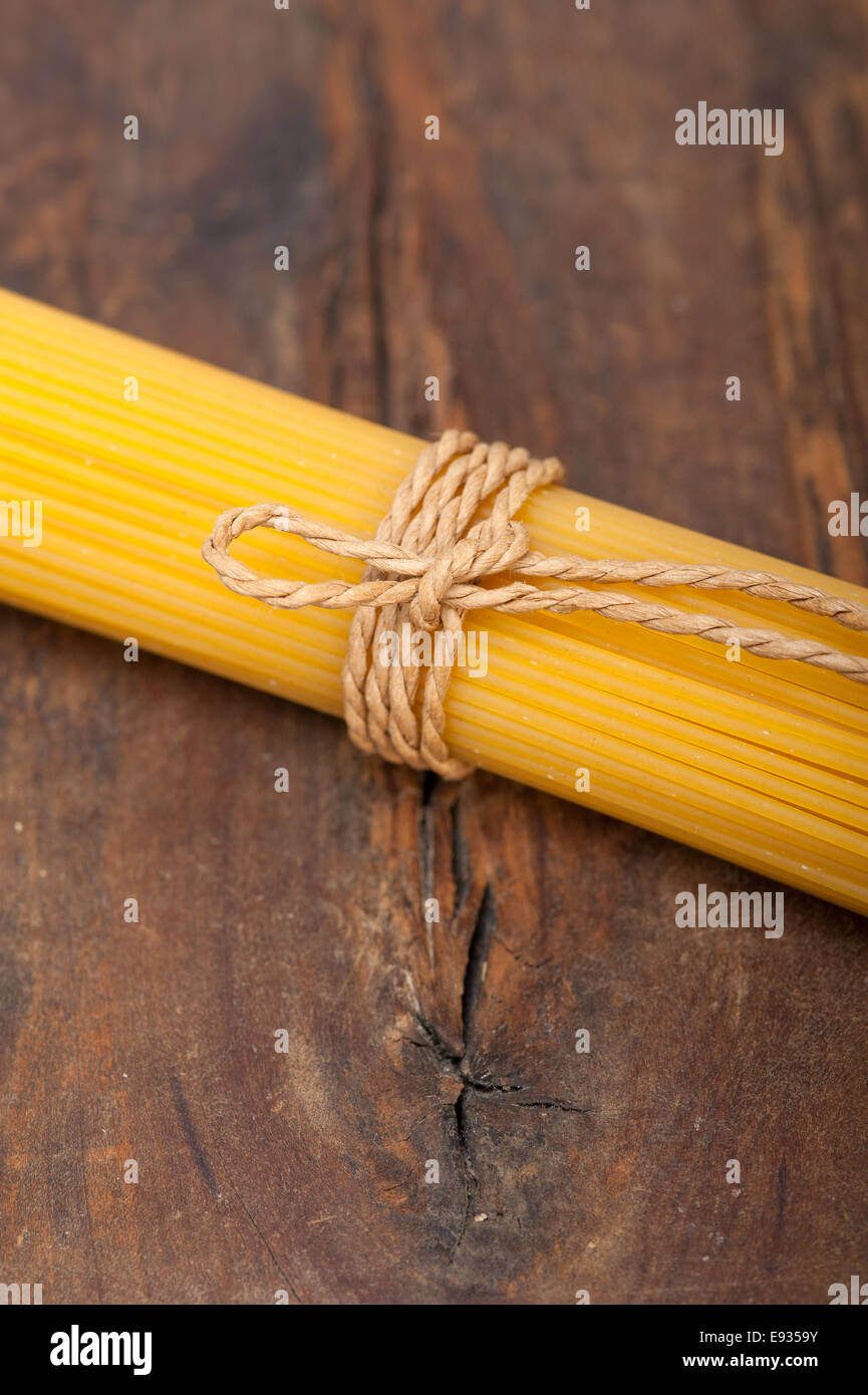 Italian pasta spaghetti tied with a rope on a rustic table Stock Photo ...