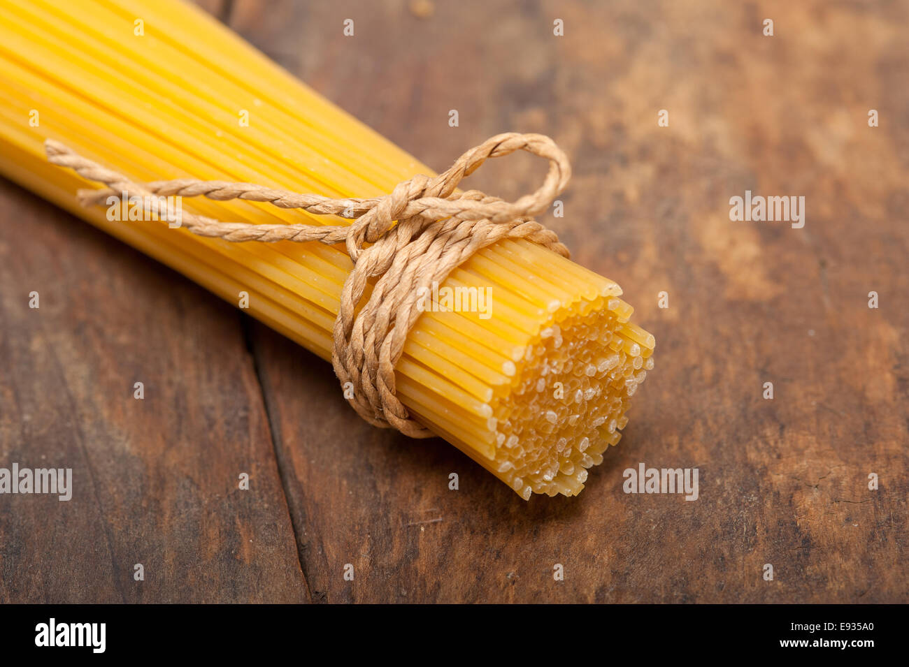 Italian pasta spaghetti tied with a rope on a rustic table Stock Photo ...
