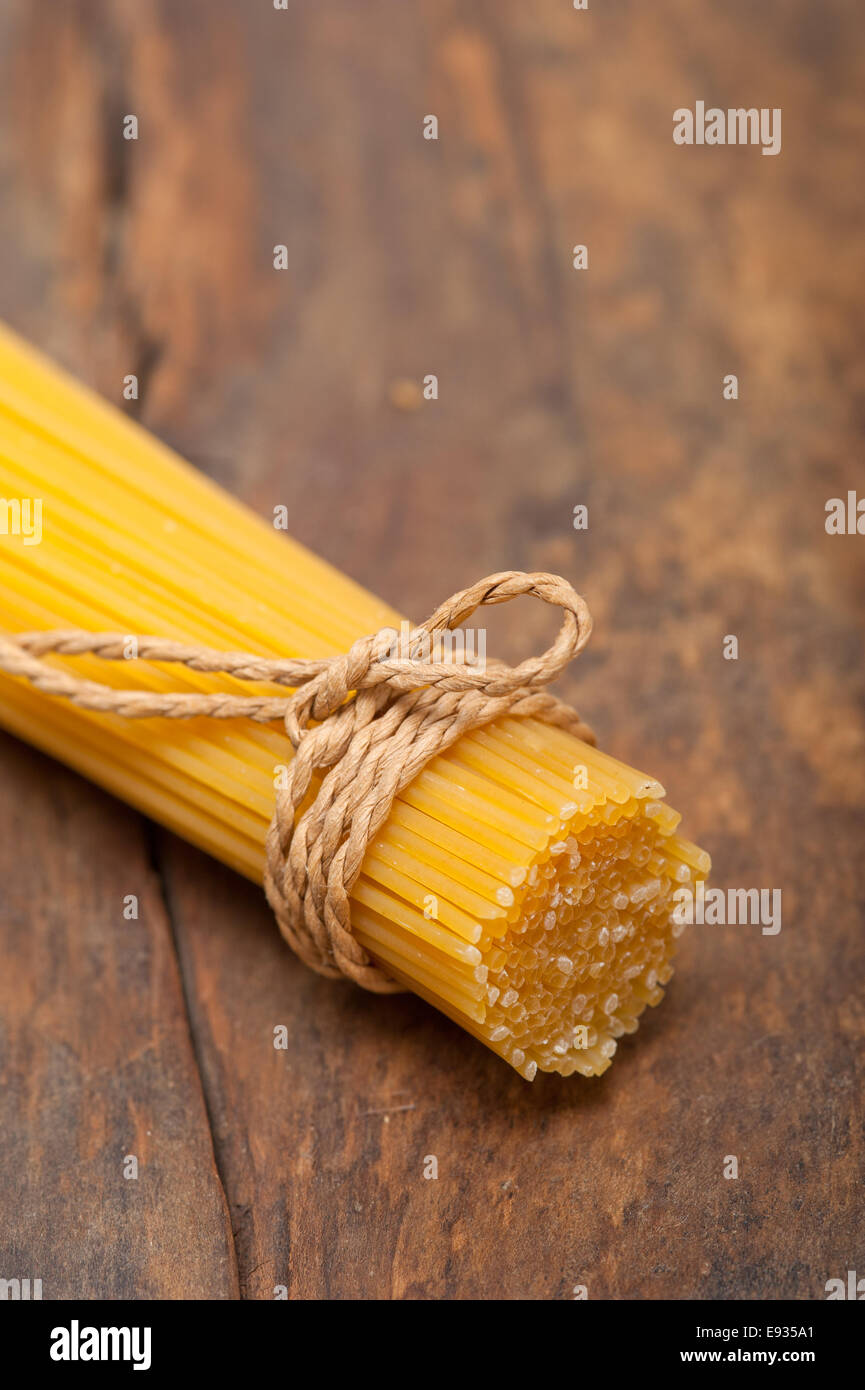 Italian pasta spaghetti tied with a rope on a rustic table Stock Photo ...