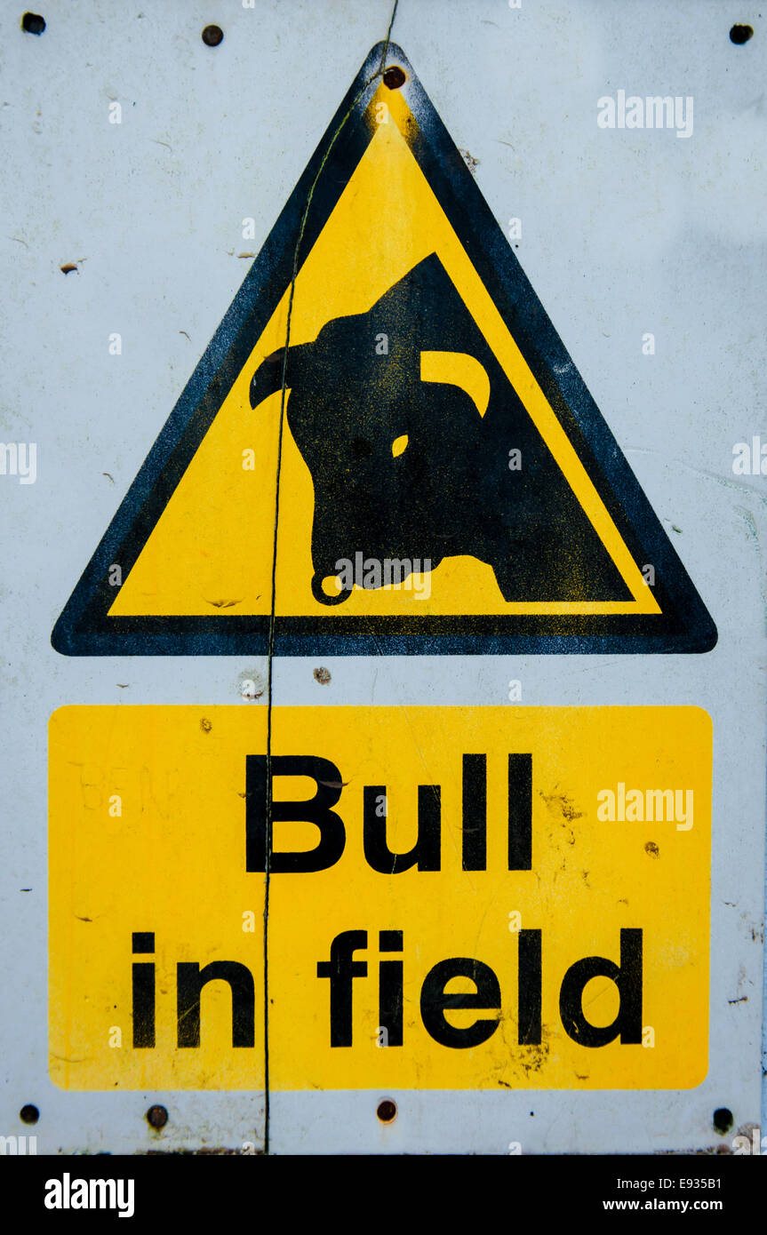 Warning sign of bull in the field, color filter applied Stock Photo - Alamy