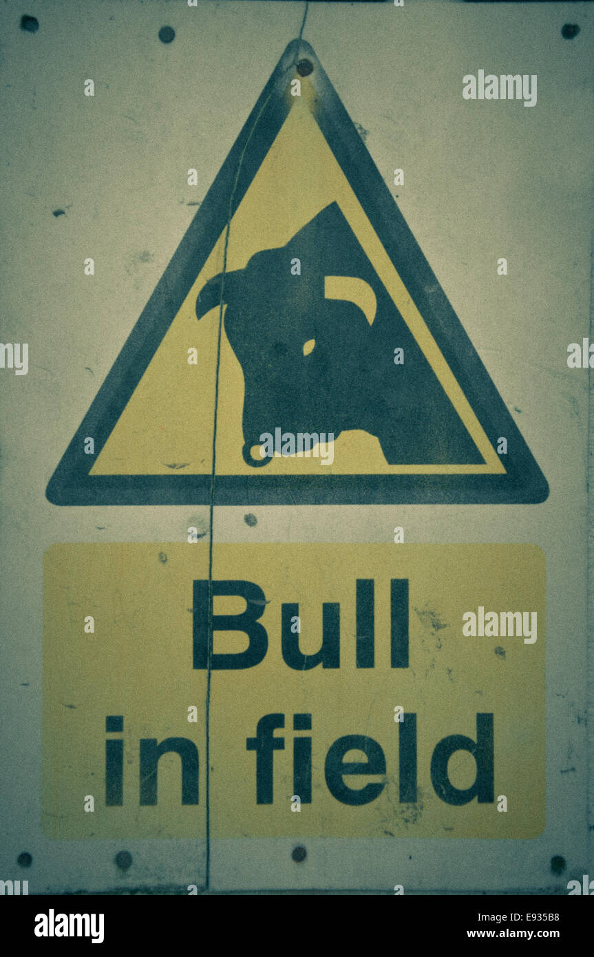 Warning sign of bull in the field, color filter applied Stock Photo - Alamy