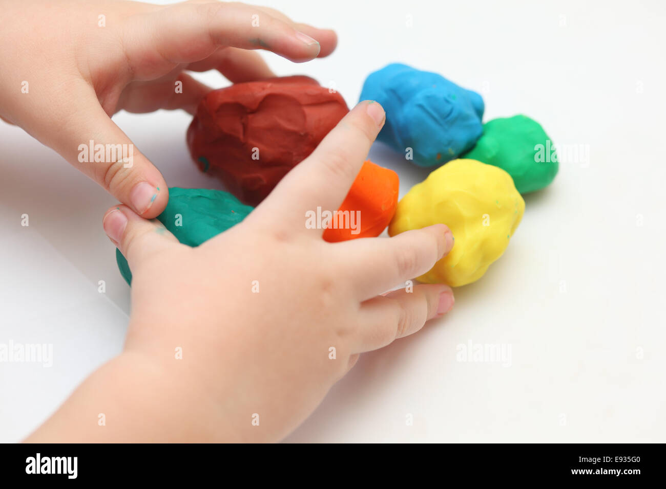 Children's hands playing with play clay Stock Photo - Alamy