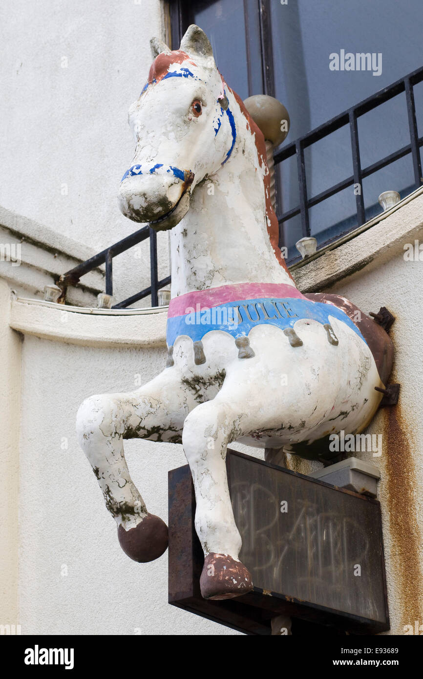 Wooden galloping horse attached to a wall on a closed down bar very run ...