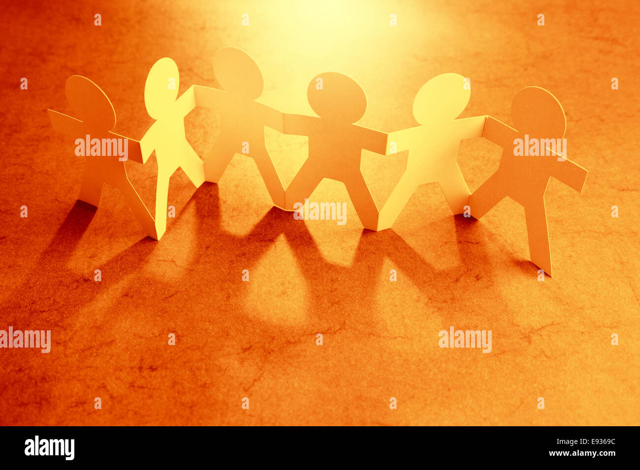 Paper doll people holding hands Stock Photo - Alamy