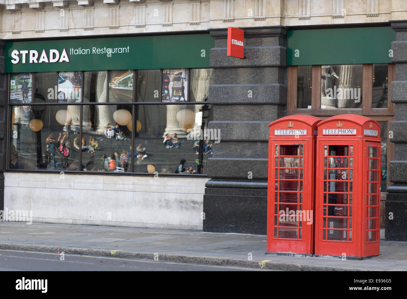 Strada Restaurant Facade with Two Red Telephone Boxes on the pavement ...