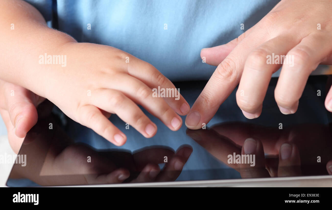 Child and mother hands with digital tablet Stock Photo - Alamy