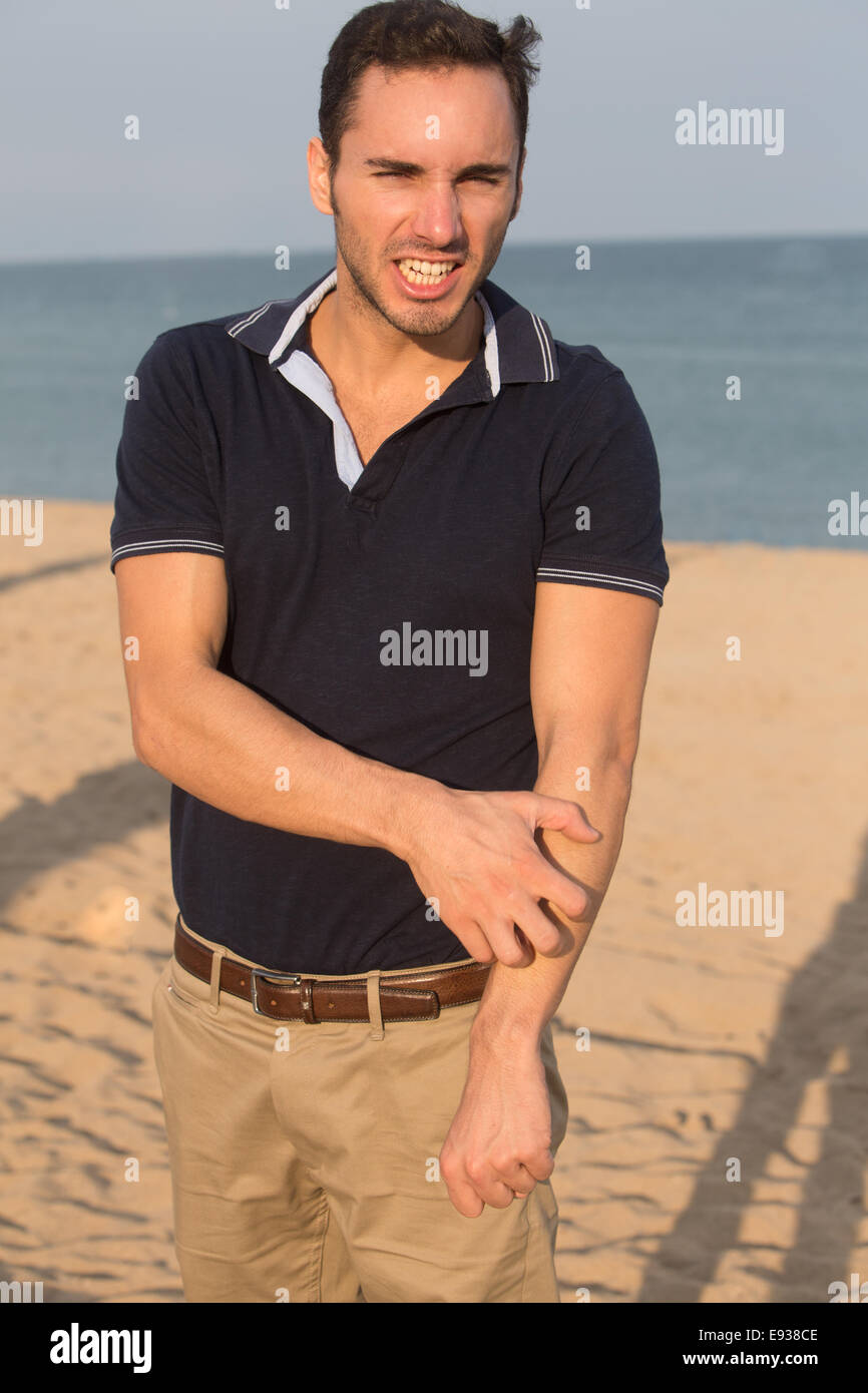 Man scratching his arm Stock Photo - Alamy