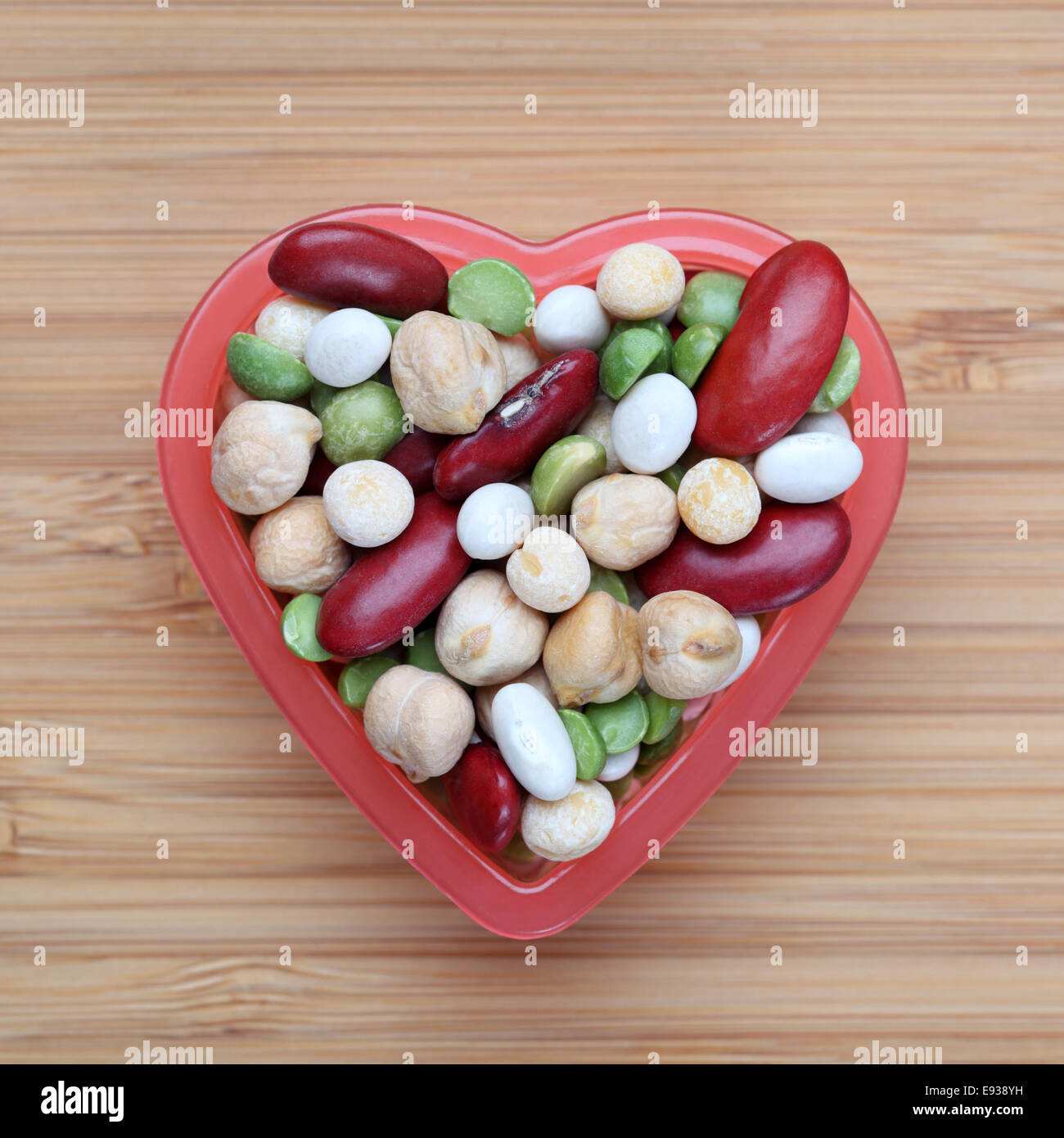 Mixed legume beans in a heart bowl. Close-up Stock Photo - Alamy