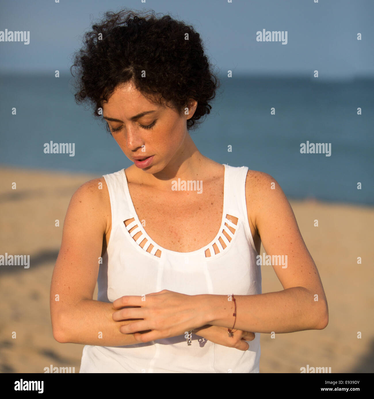 Woman scratching her arm Stock Photo - Alamy