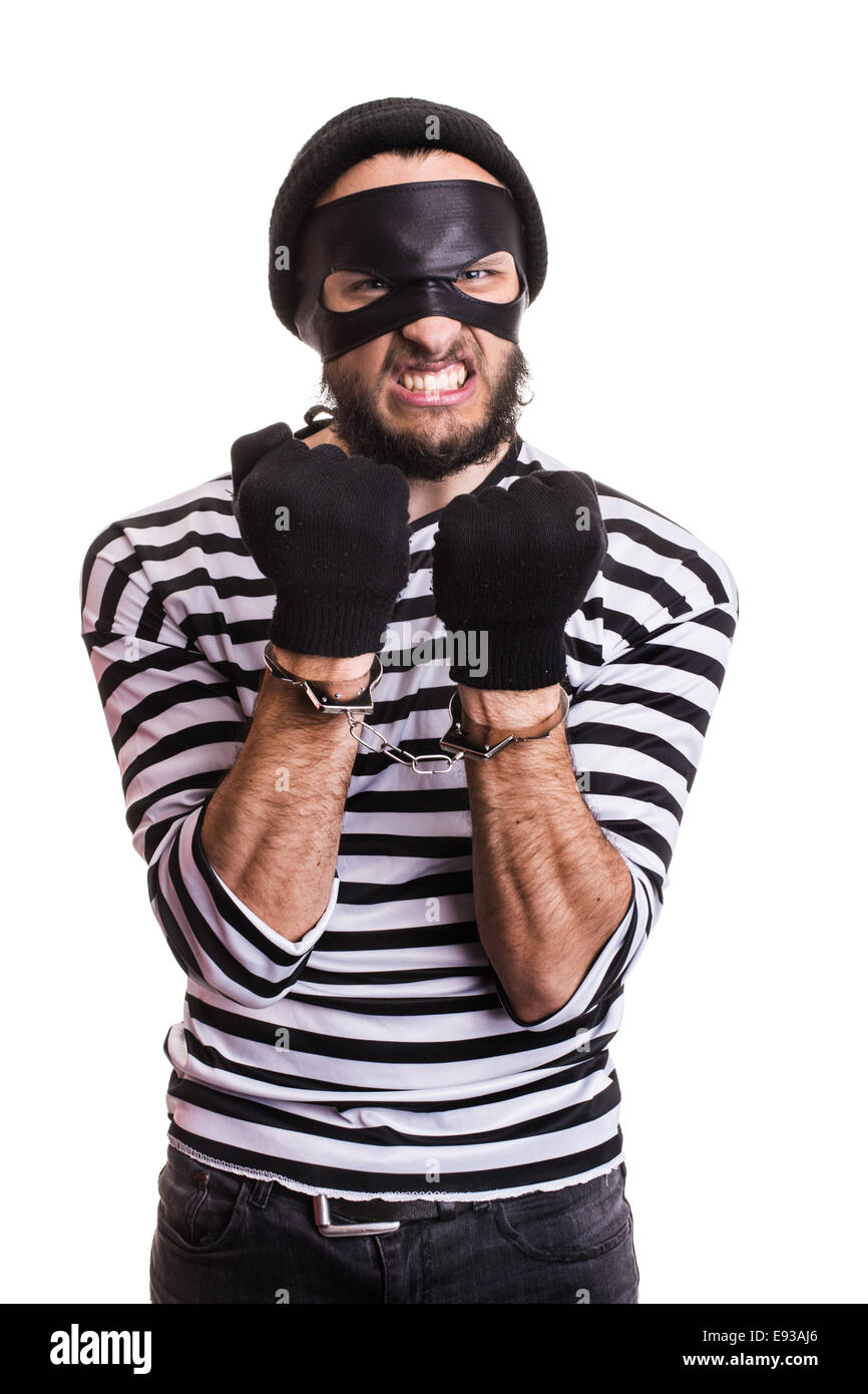 Angry burglar with handcuffs. Portrait isolated on white background ...