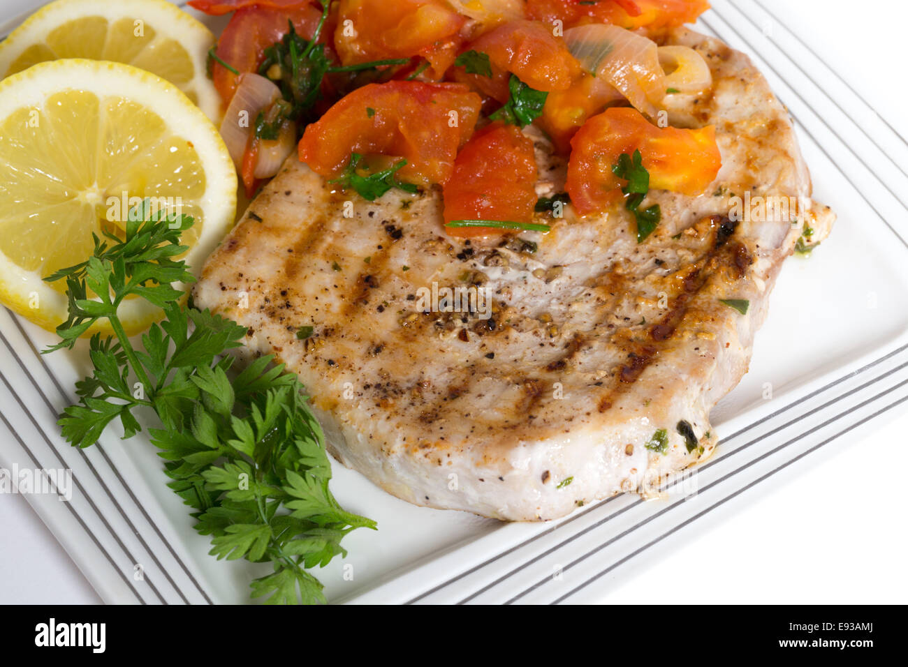 Marlin steak grilled and served with a tomato onion salsa viewed from ...