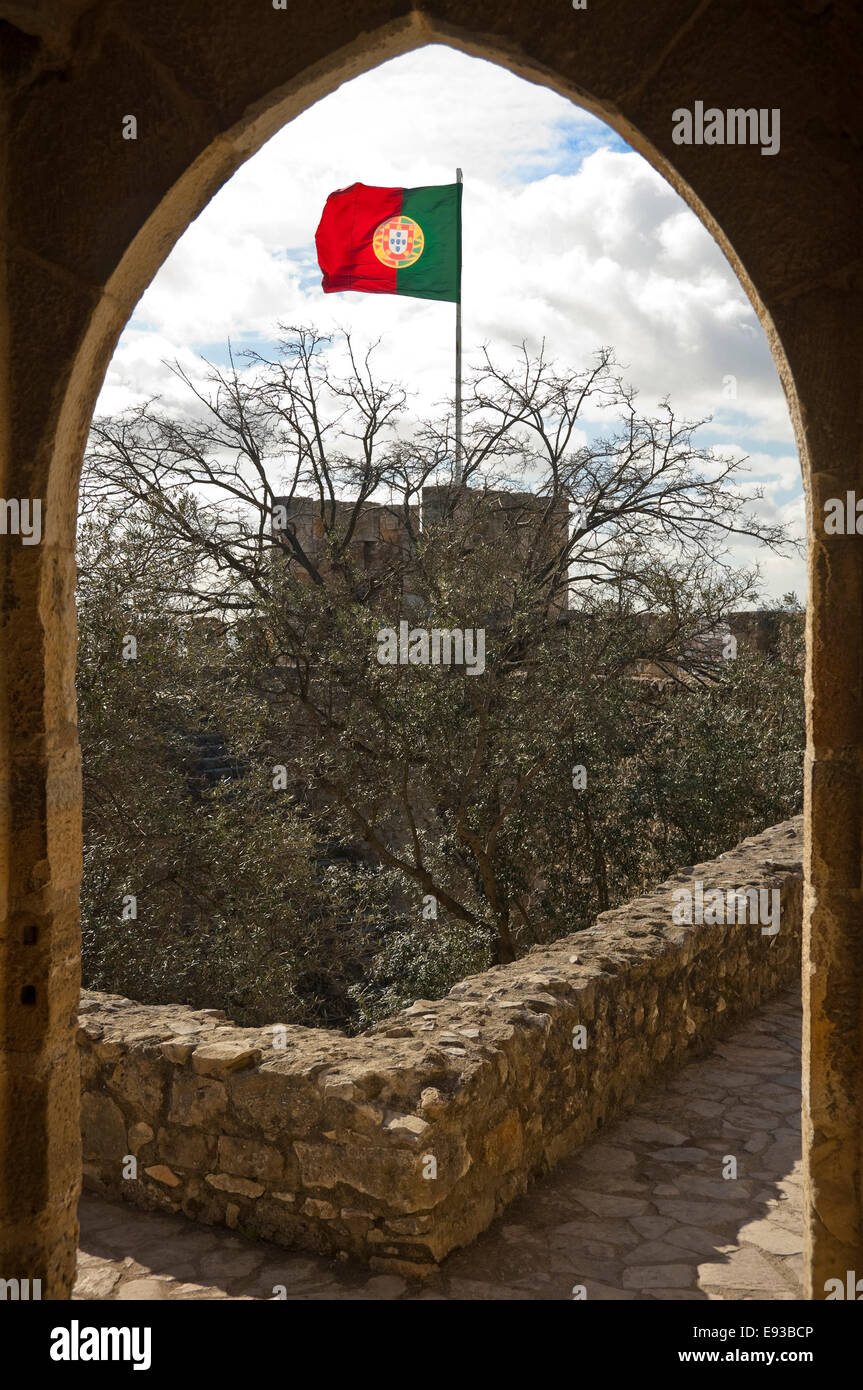 Vertical view through an archway of the national flag of Portugal in ...