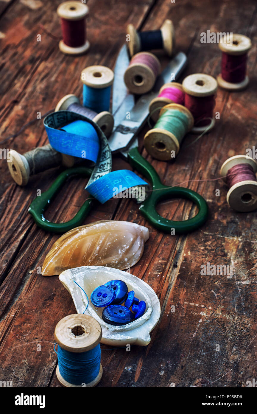 threads of different types,colors and lengths on wooden background ...